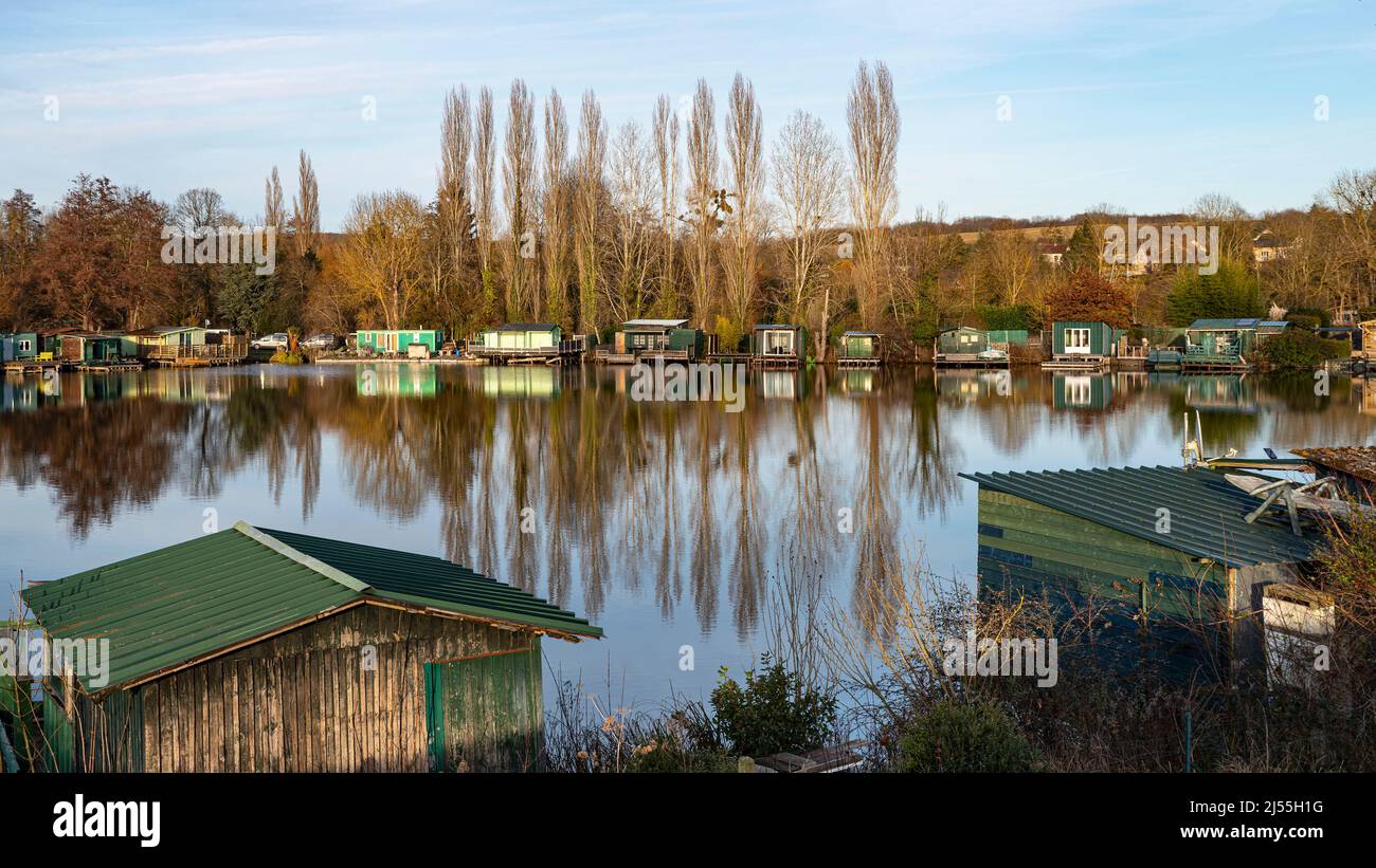 Fisherman's huts on the banks of a river and a pond Stock Photo - Alamy
