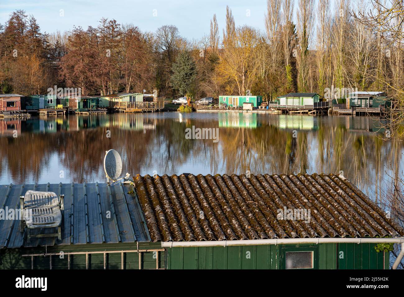 Fisherman's huts on the banks of a river and a pond Stock Photo - Alamy