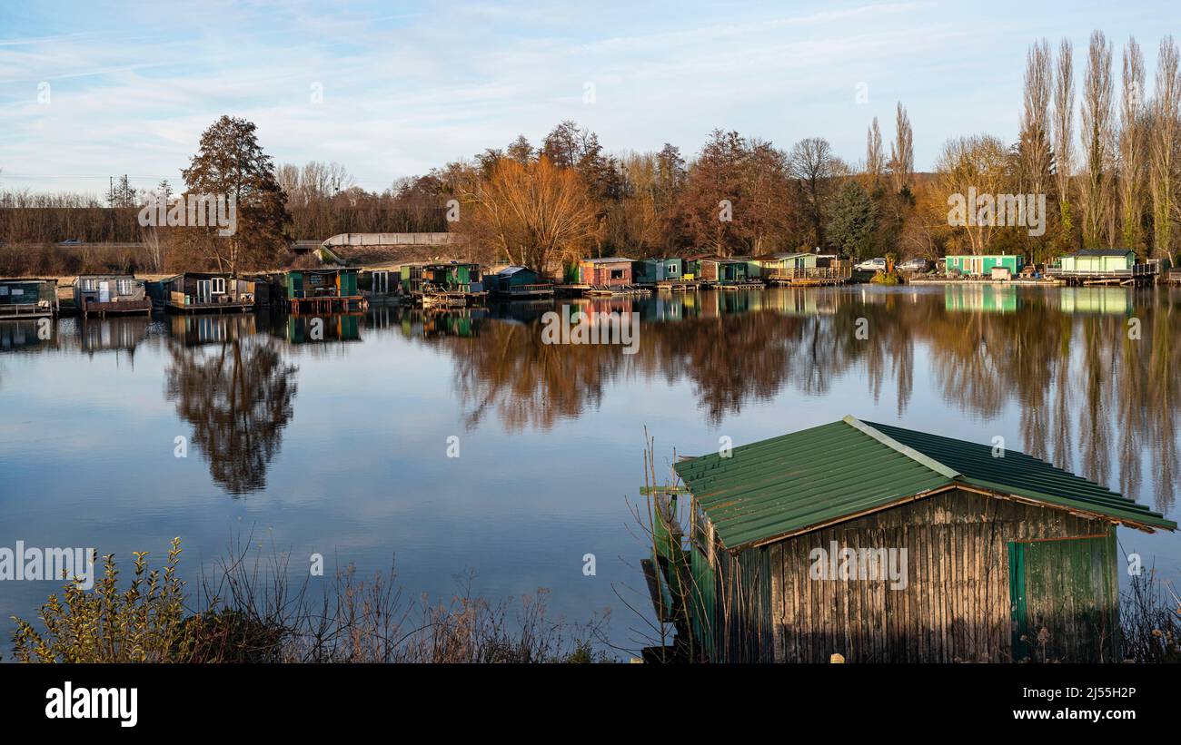 Fisherman's huts on the banks of a river and a pond Stock Photo - Alamy
