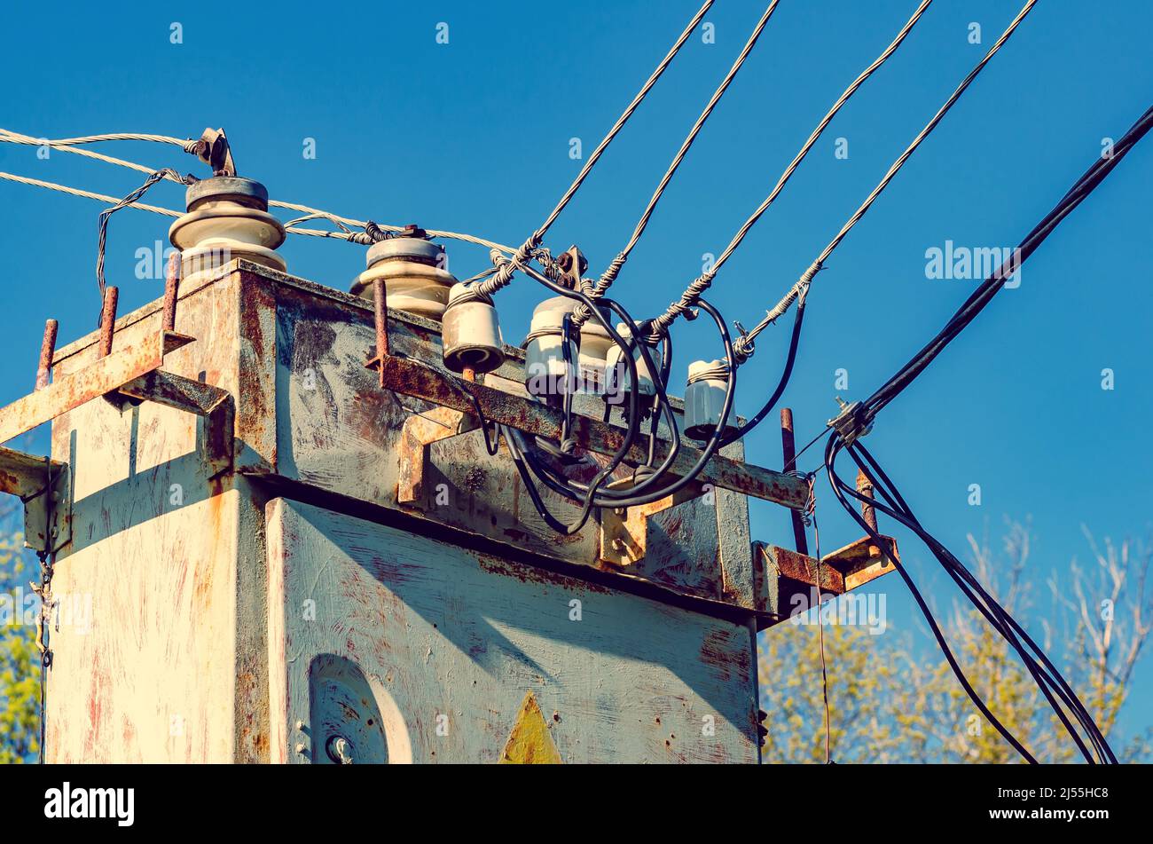 Transformer booth with high voltage power lines. Blue sky background ...