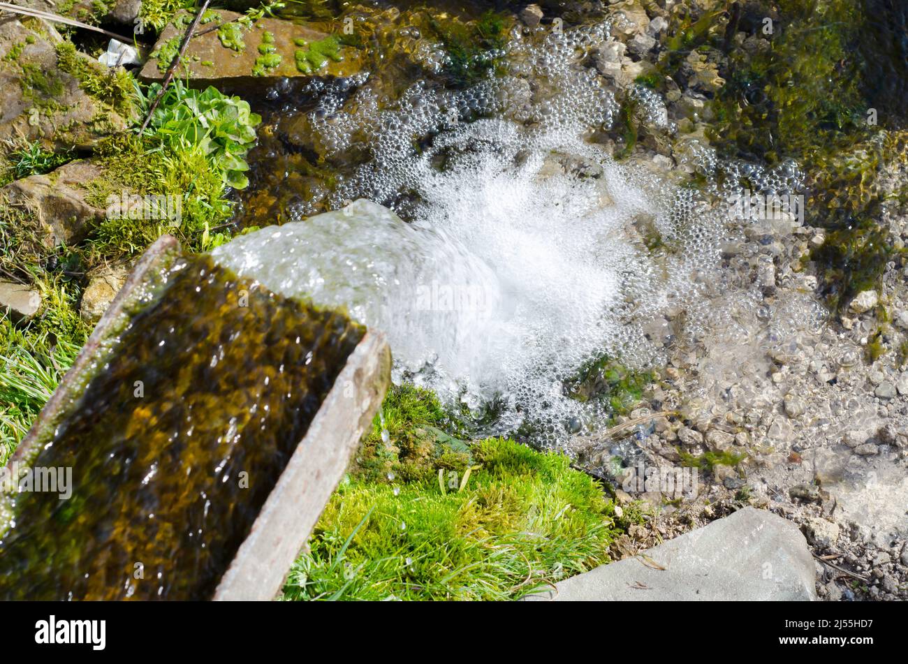 Top view of stream of clean spring water. Transparent stream, bubbles ...