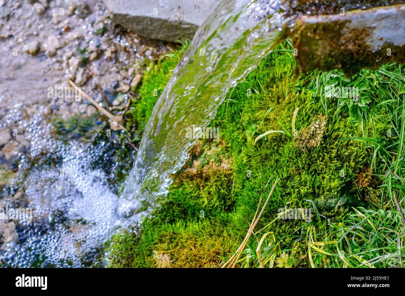 Refreshment with cold clean water on hot summer day. Flow of clean ...