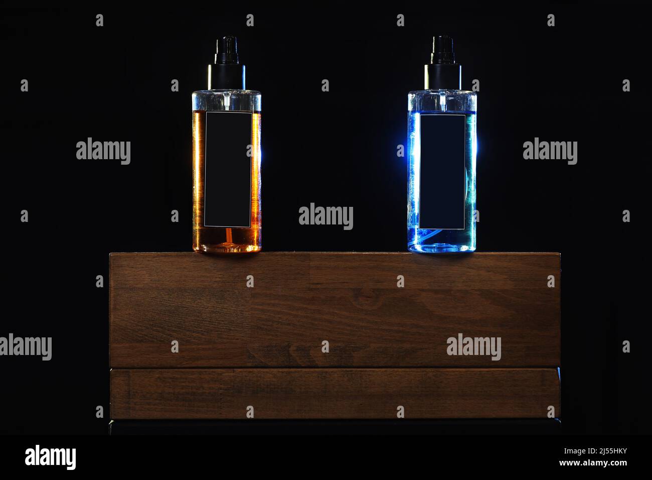 two bottles with yellow and blue liquid. two spray spraying cans on ...