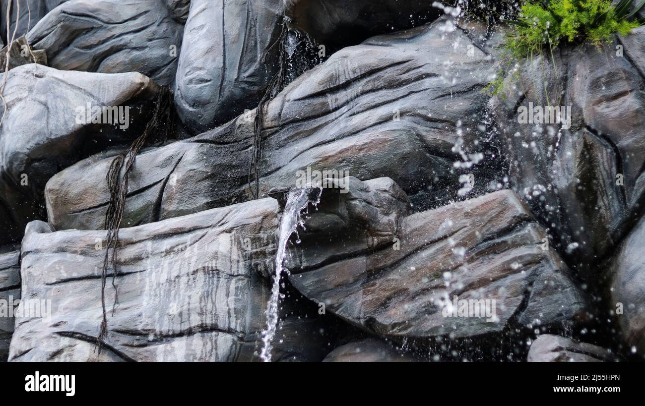 The artificial rock is poured into the water Stock Photo - Alamy