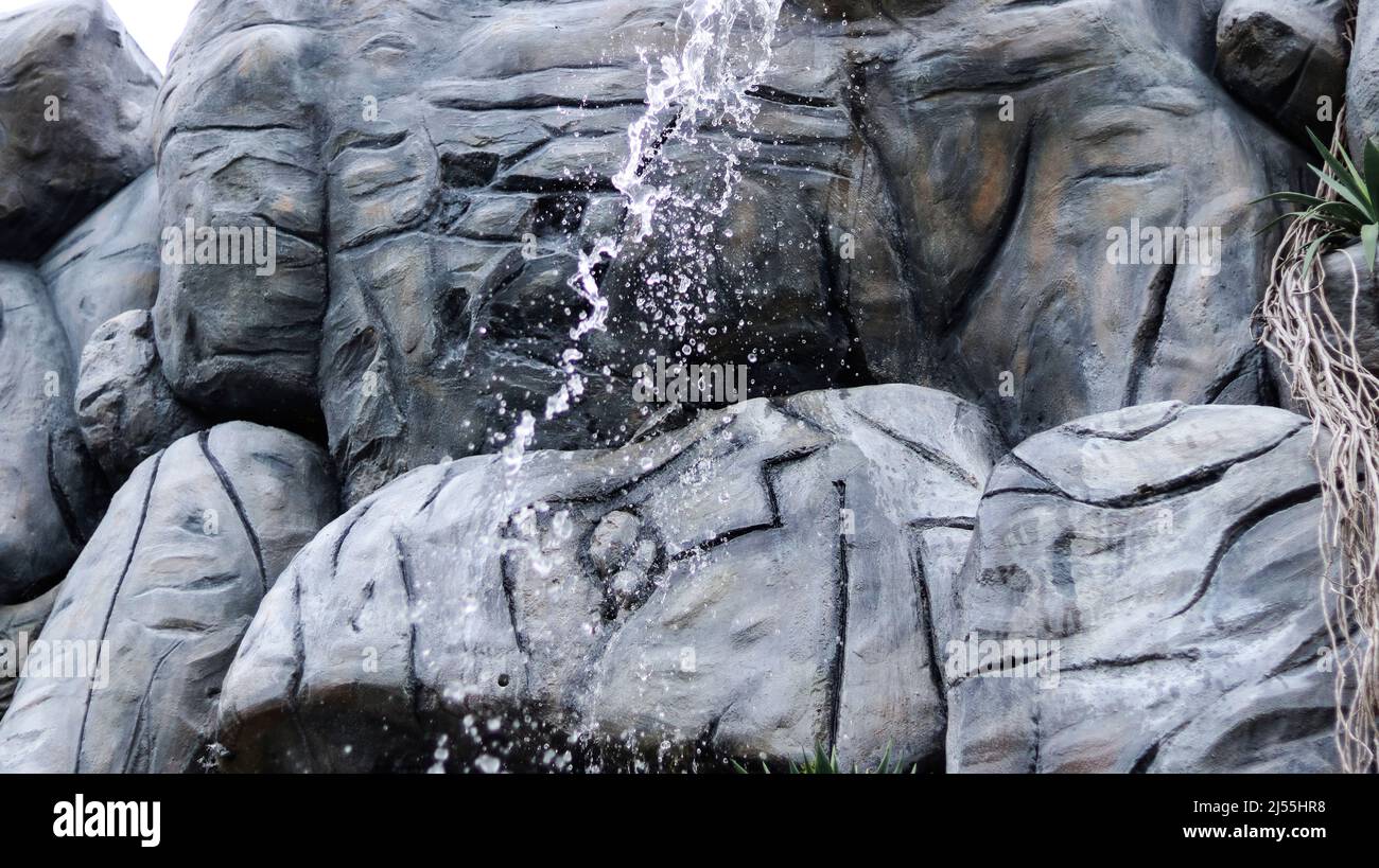 The artificial rock is poured into the water Stock Photo - Alamy