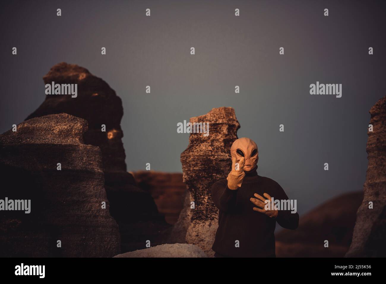 Alien mask people doing peace sign with hand and touching heart for ...