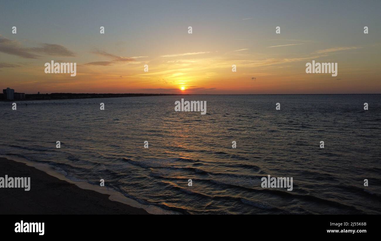 Sun above water during sunset Stock Photo - Alamy