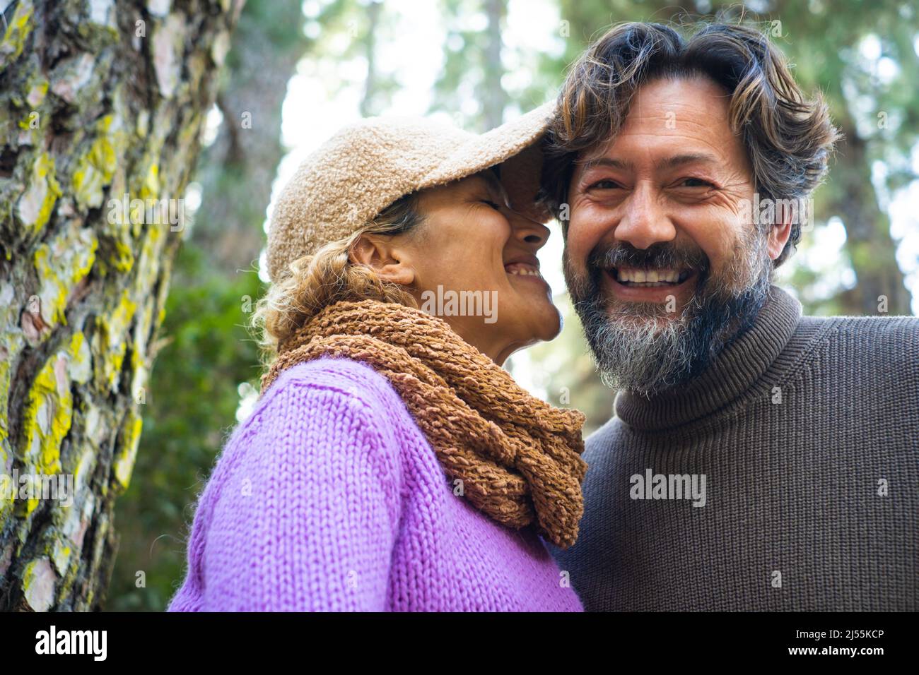 Man and woman adult couple smile and stay closer in the park. Outdoor ...