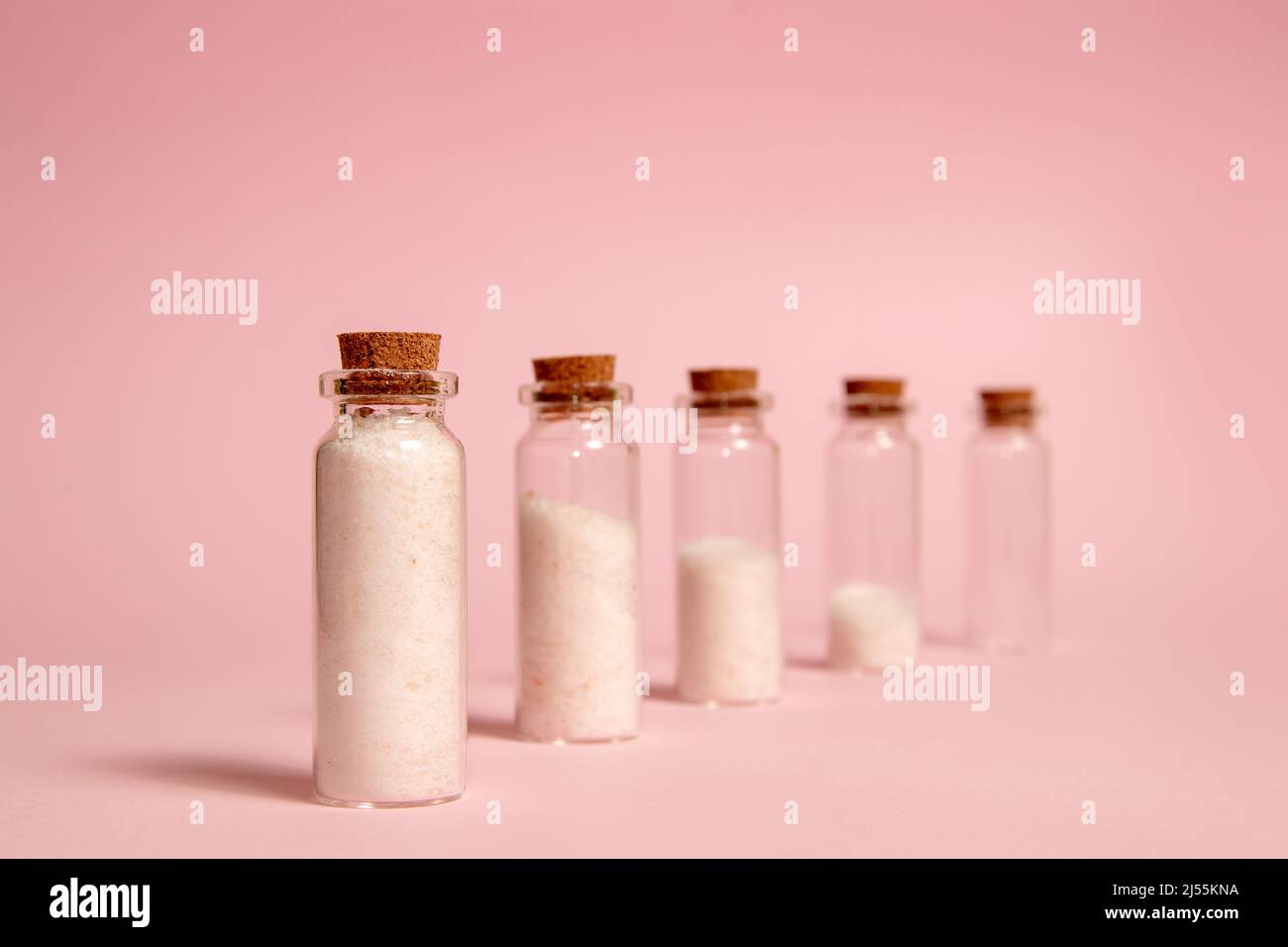 Pink Himalayan salt in glass bottles. Little bottles with cork stopper ...