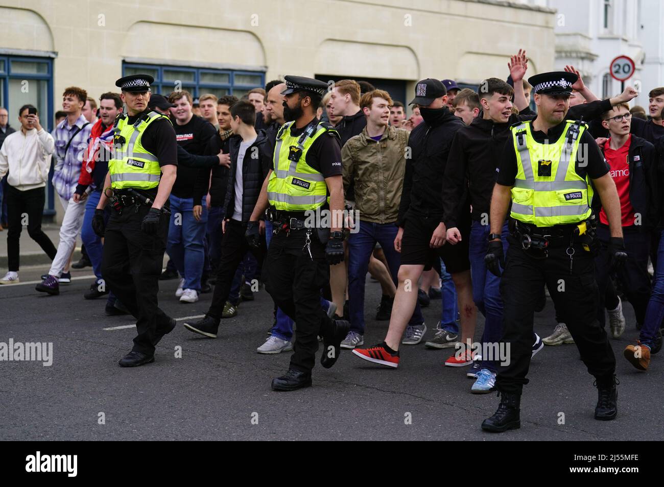 Arsenal fans are led to the stadium by police ahead of the Premier ...