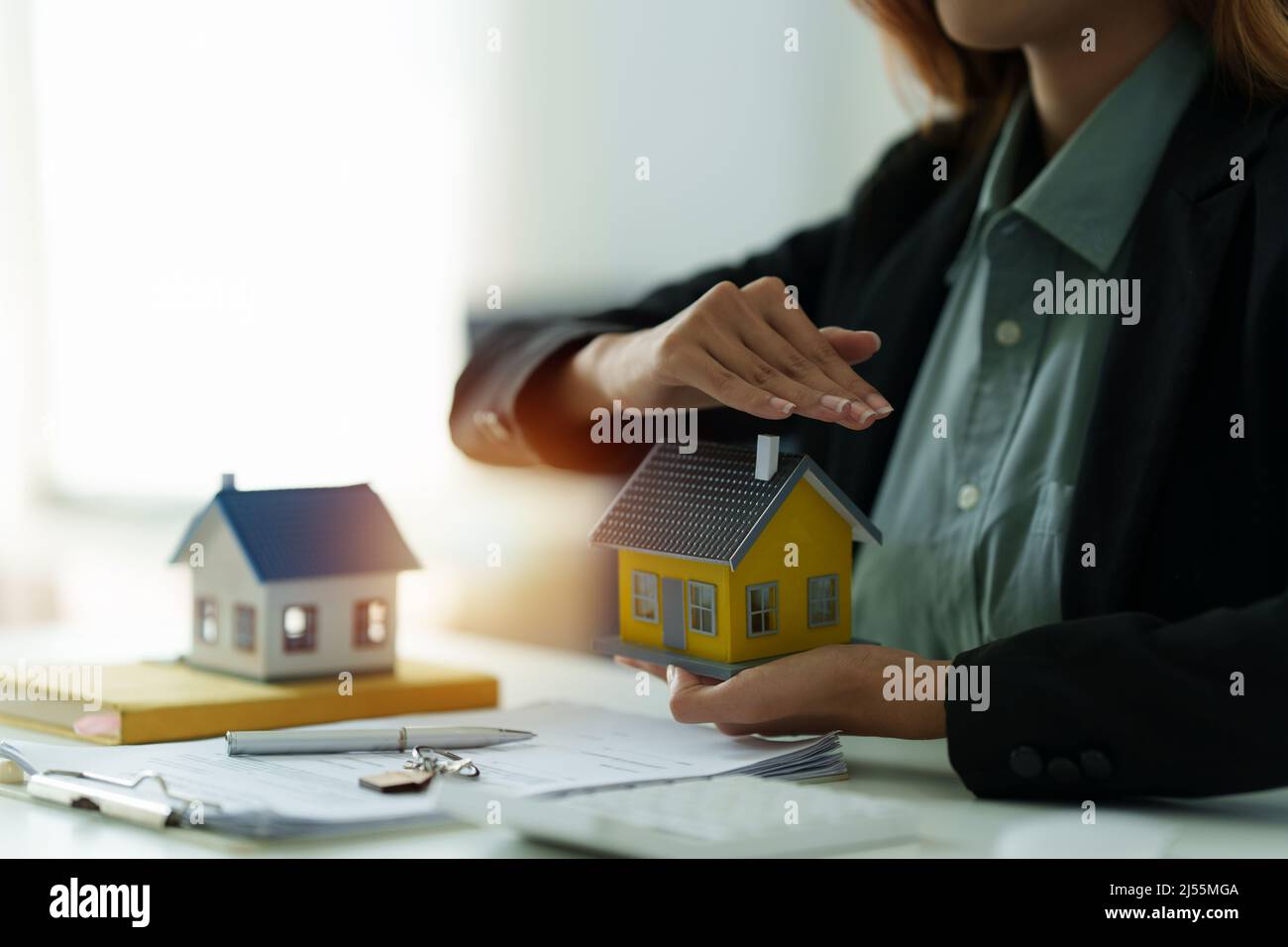 A woman holding and checking house model .Real Estate House Appraisal ...