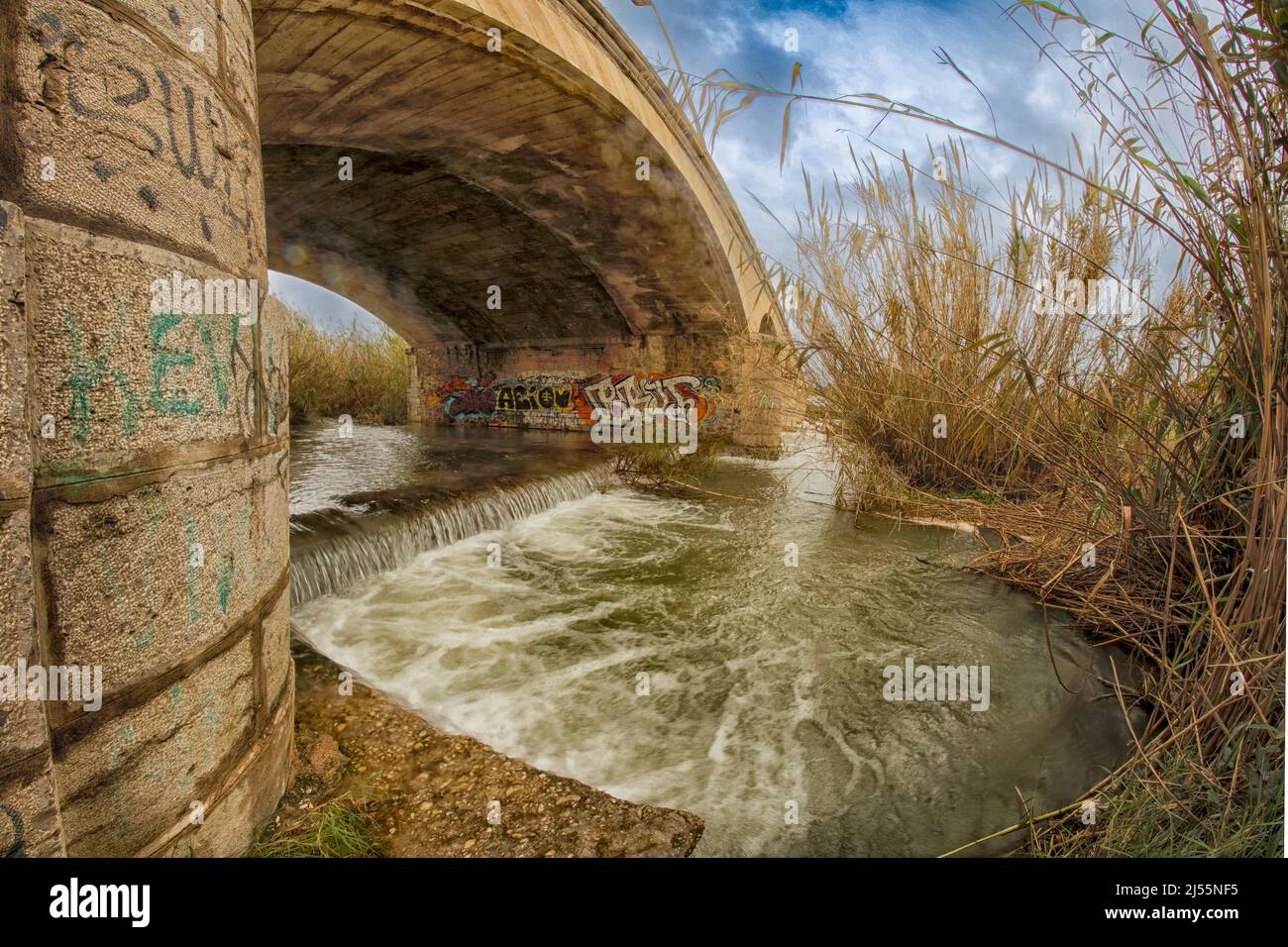 Natural landscape of Algar river in flood rushing under the road bridge ...