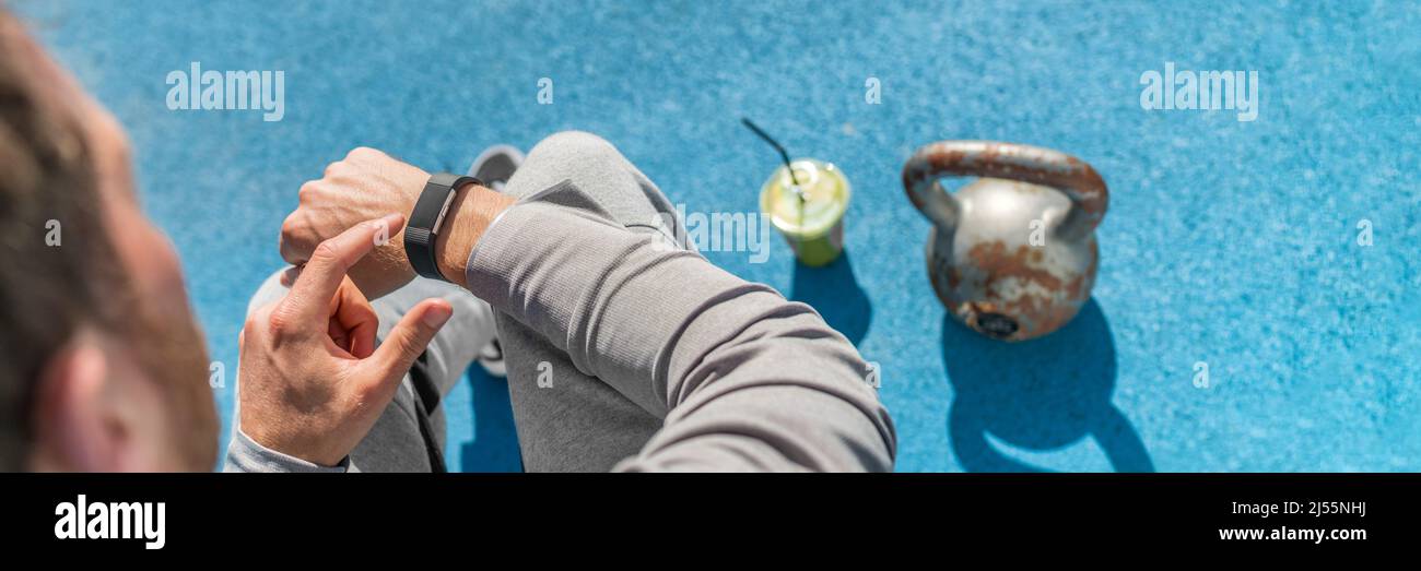 Smartwatch fitness man using watch activity tracker at athletics ...