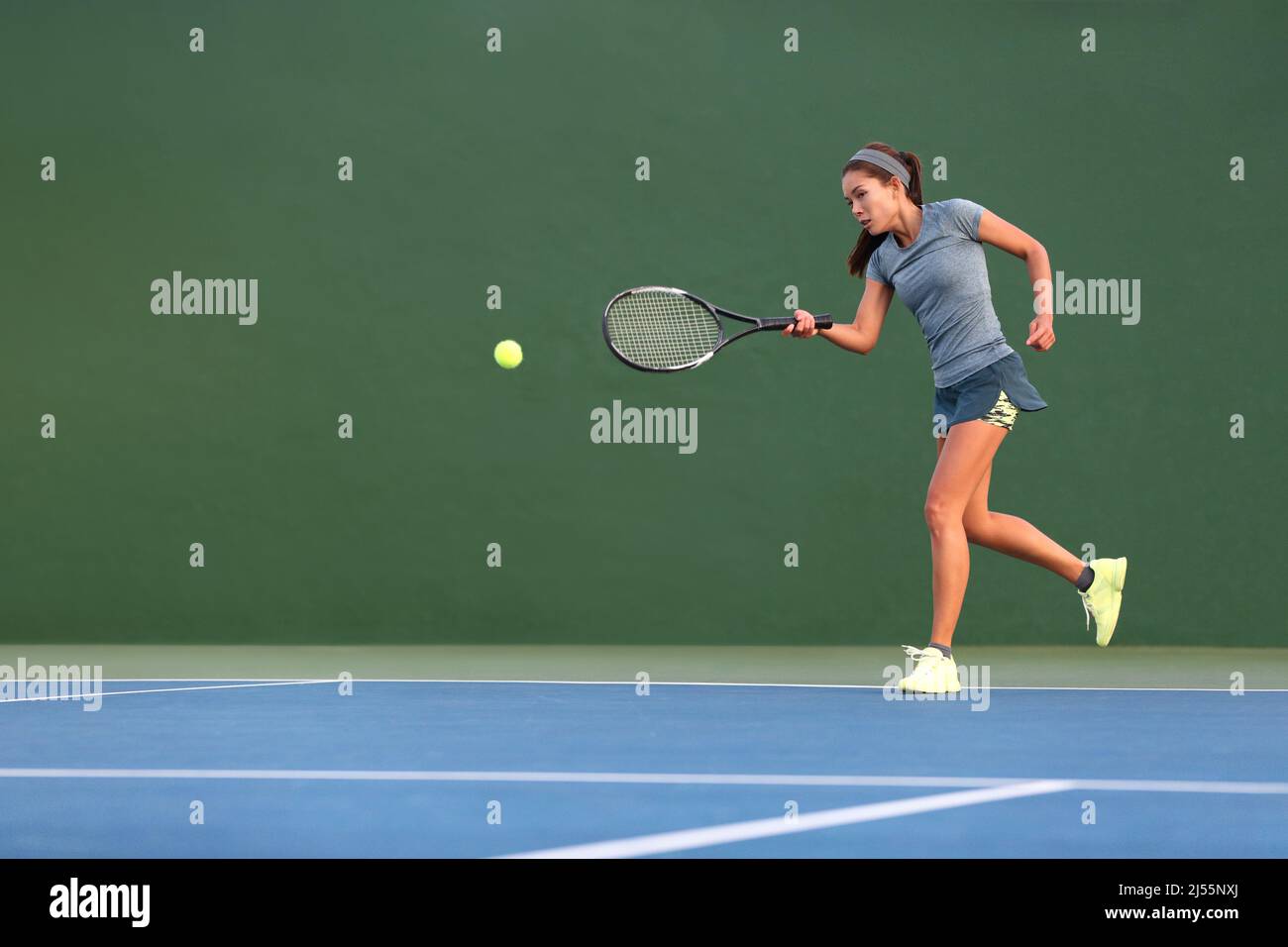 Tennis player man banner hitting ball with racket on green horizontal ...
