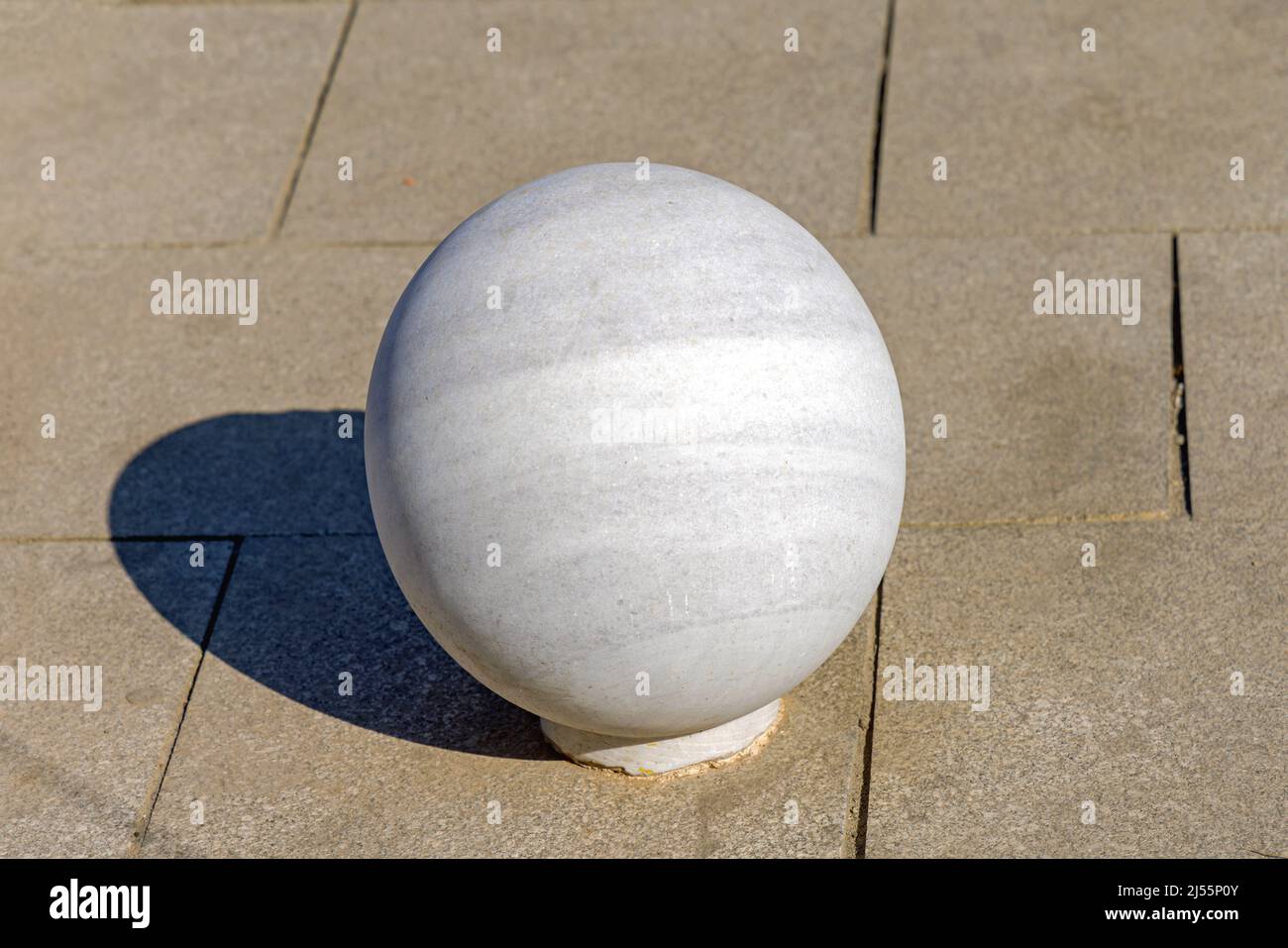 Very Large White Marble Ball at Street Pavement Stock Photo - Alamy