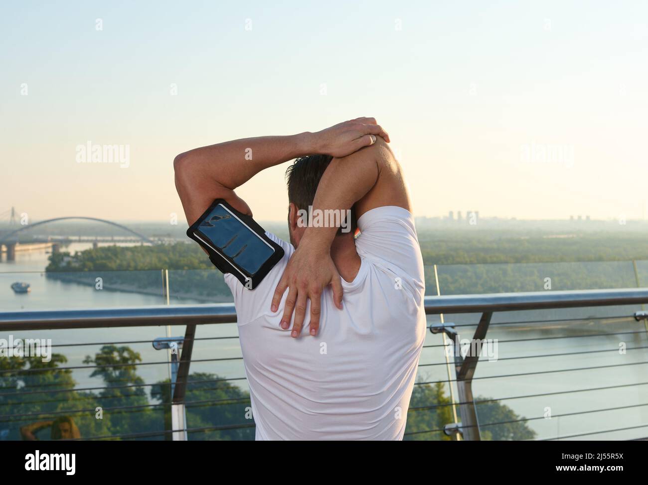 Rear view of an athlete doing sports. Muscular build sportsman standing ...