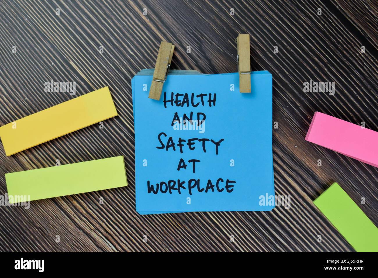 Health and Safety At Workplace write on sticky notes isolated on Wooden ...