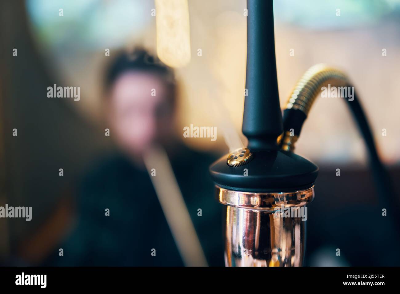 Close-up of black pipe and golden shisha flask Stock Photo - Alamy