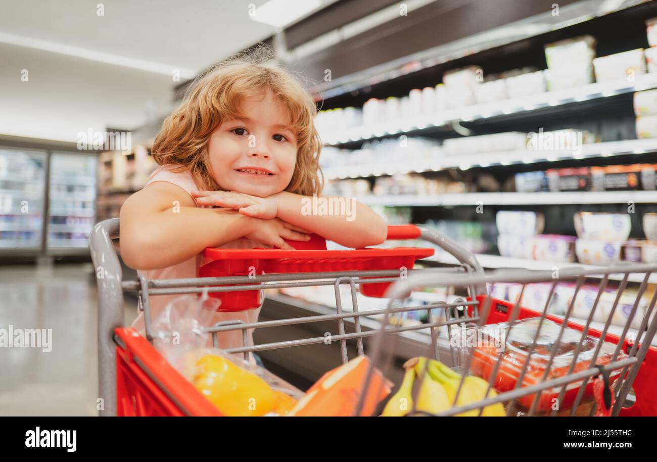 Kid with shopping cart in a grocery store. Grocery shopping Stock Photo ...