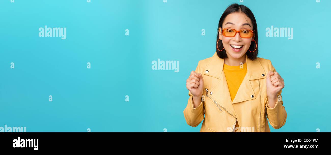 Image of enthusiastic young asian woman celebrating, triumphing ...