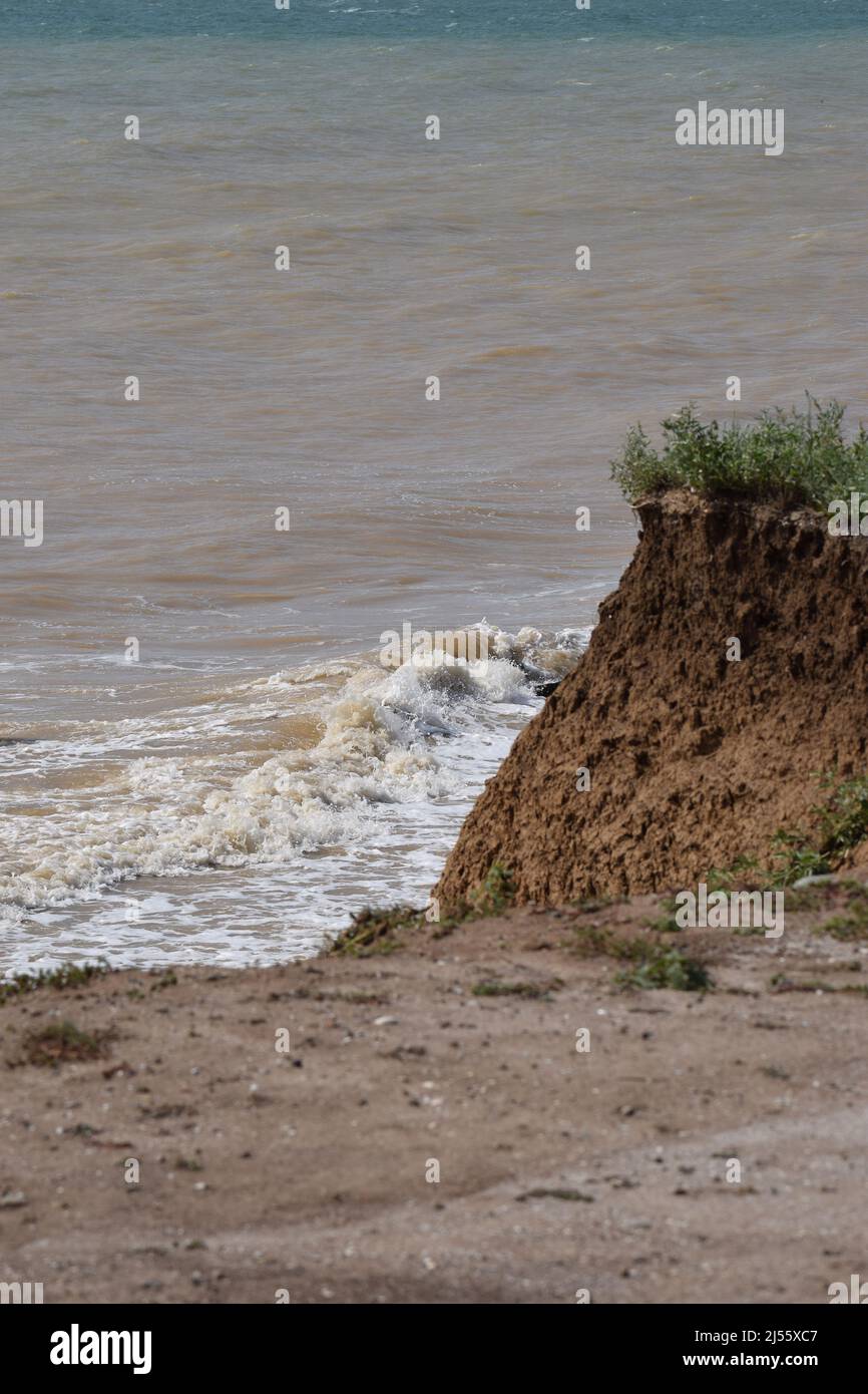 Sea cliffs of boulder clay in front of beaches. Clay Cliffs and Beach with Blue Sky and Water ...