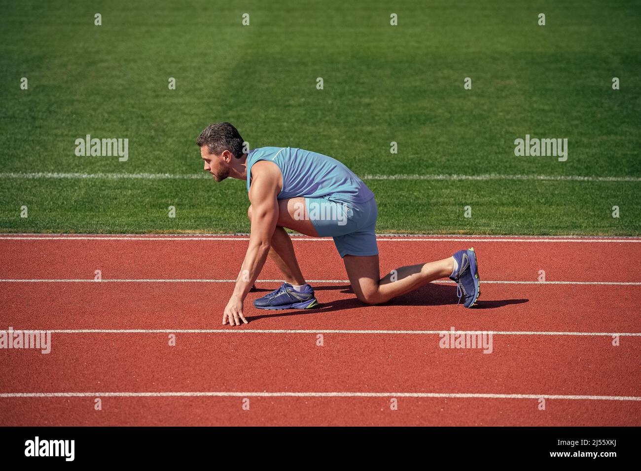 Runner ready to go. Athlete runner prepare to race at stadium. Running ...