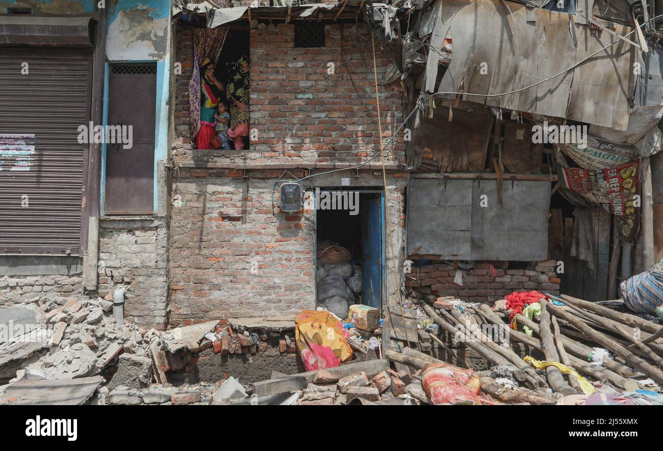 Local residents look on a after a bulldozer demolished an illegal ...