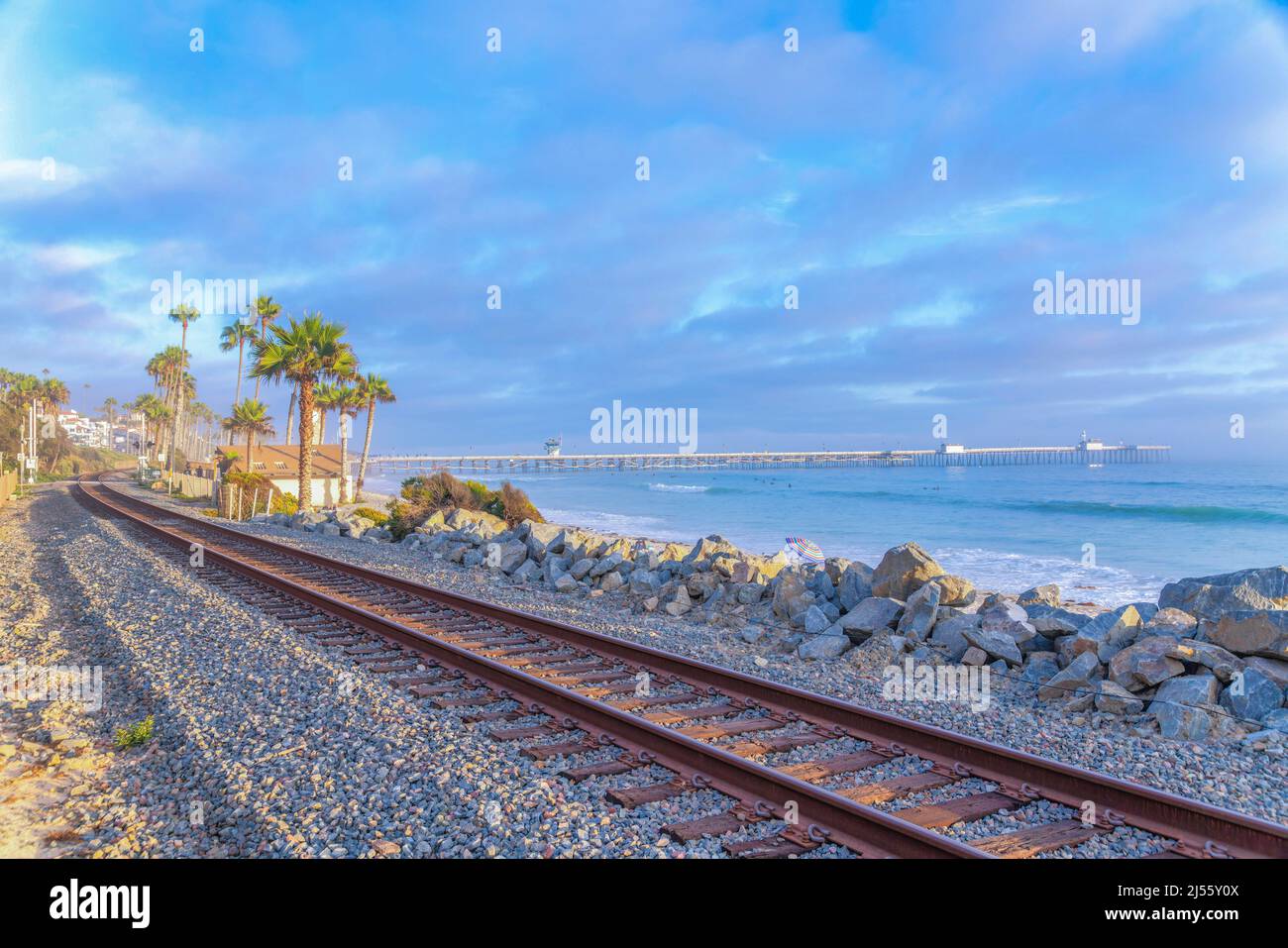 Rusty train tracks with a view of the ocean and pier at San Clemente ...