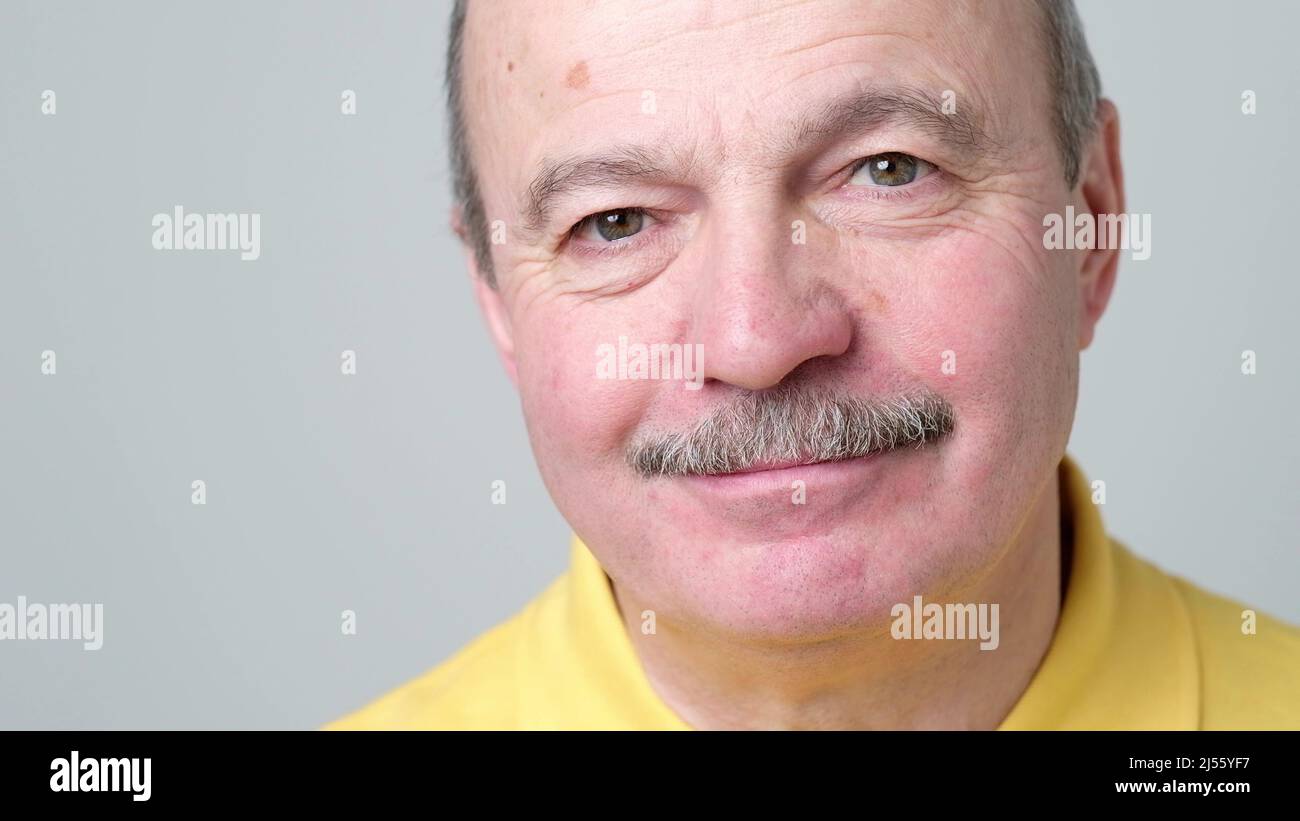 Close up video on senior smiling man. Positive human facial emotion ...