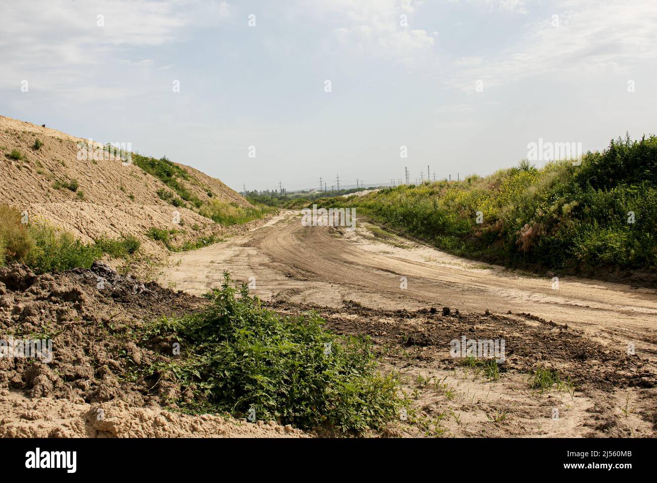A temporary road made of clay soil during the construction of a road ...