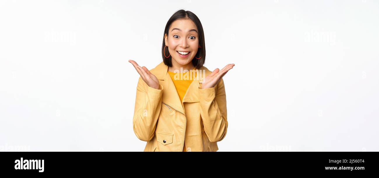 Image of asian woman looking surprised, amazed reaction, shocked face ...