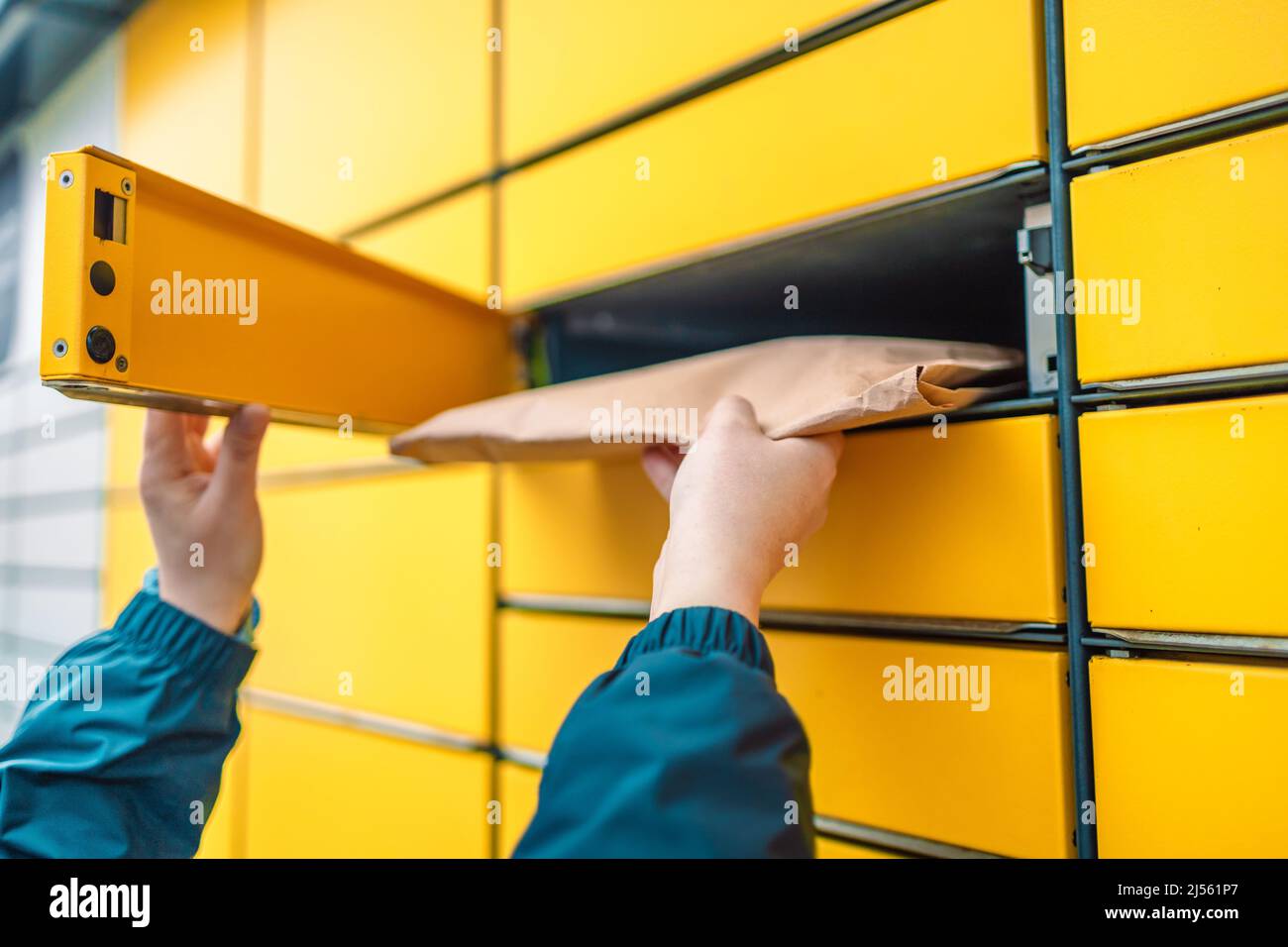 Caucasian woman receive parcel in automated self service post terminal ...
