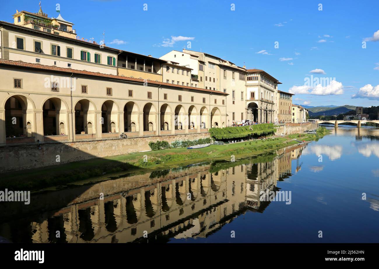 Long arcade with the reflection on the river Arno called CORRIDOIO ...