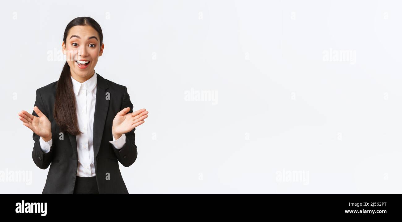 Happy satisfied asian female businesswoman react to great news, raising ...