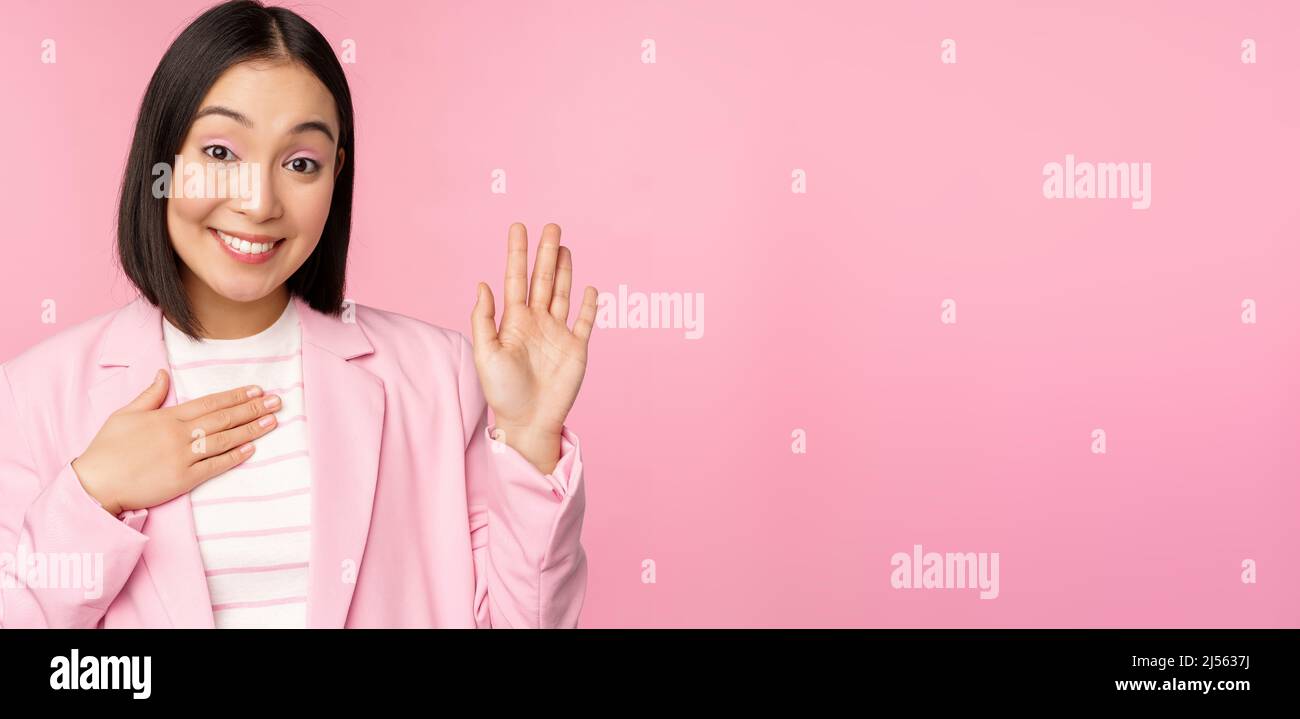 Portrait of cute asian businesswoman raising hand, introduce herself in ...