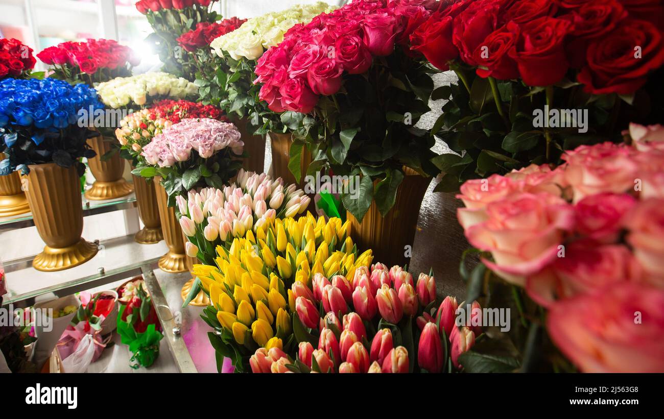 Many different colors on the stand table in the flower shop. Showcase ...