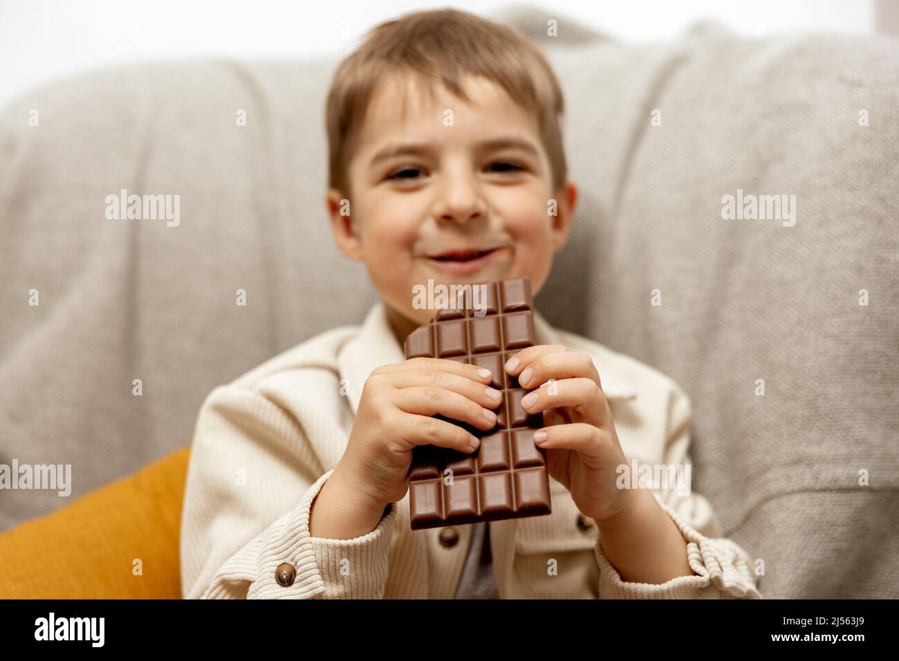 Cute boy eating chocolate hi-res stock photography and images - Alamy