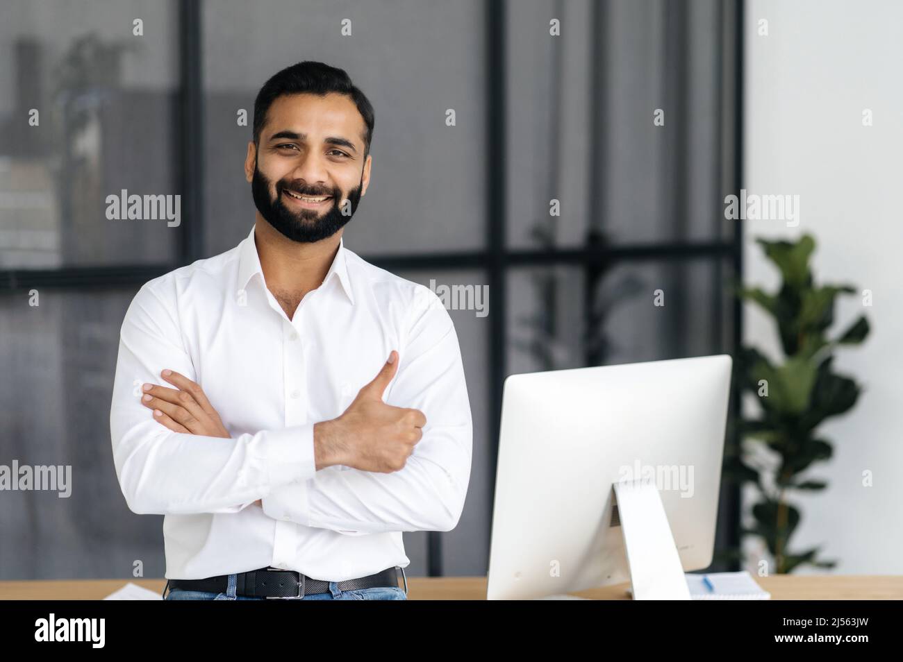 Portrait successful confident indian or arabian business man, company ceo, trader, wearing white ...