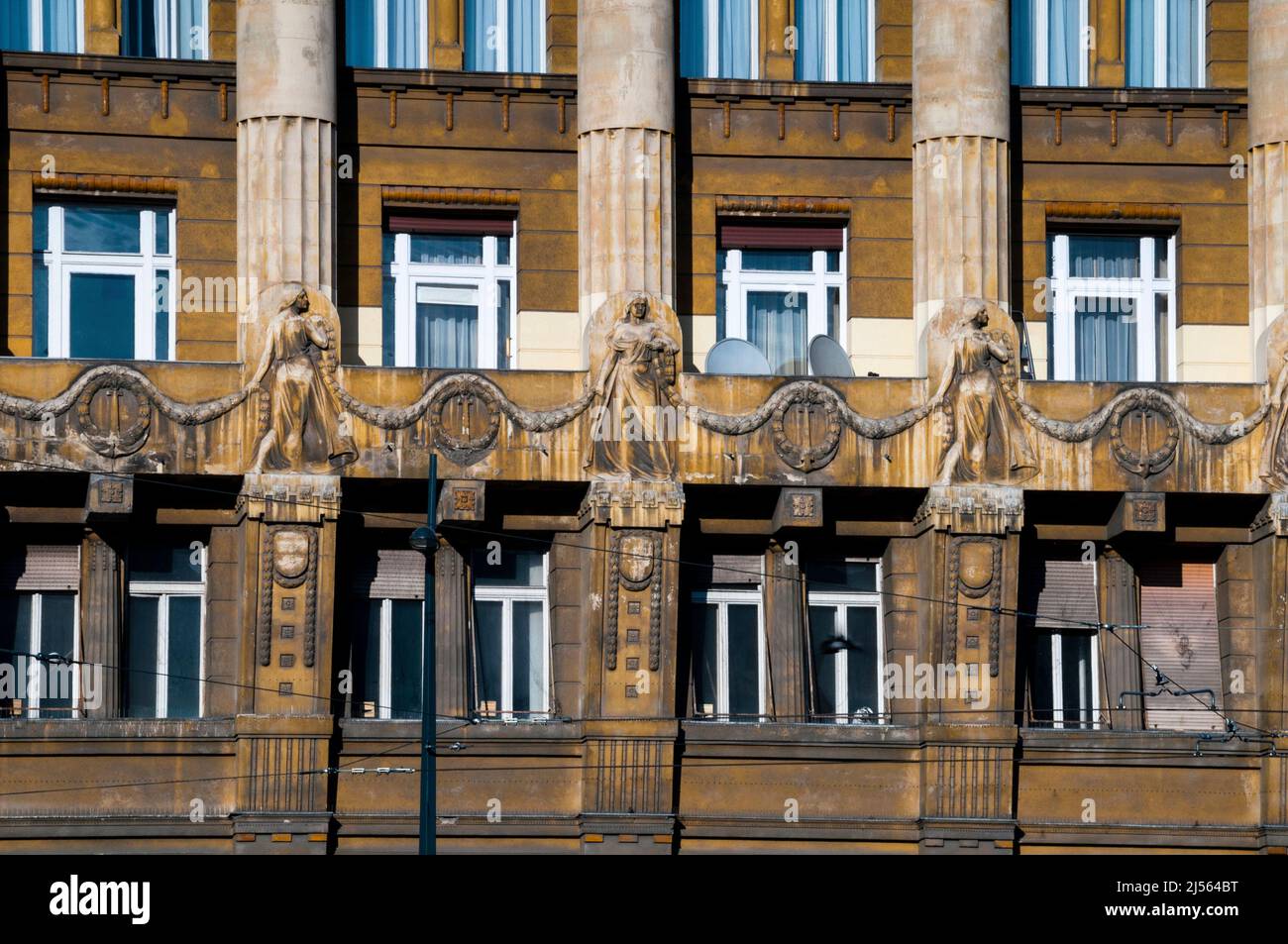 Fluted half columns, bas relief statues and wreaths on a historic ...