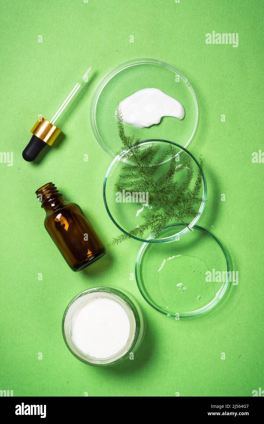 Cosmetic laboratory concept at green background top view Stock Photo ...