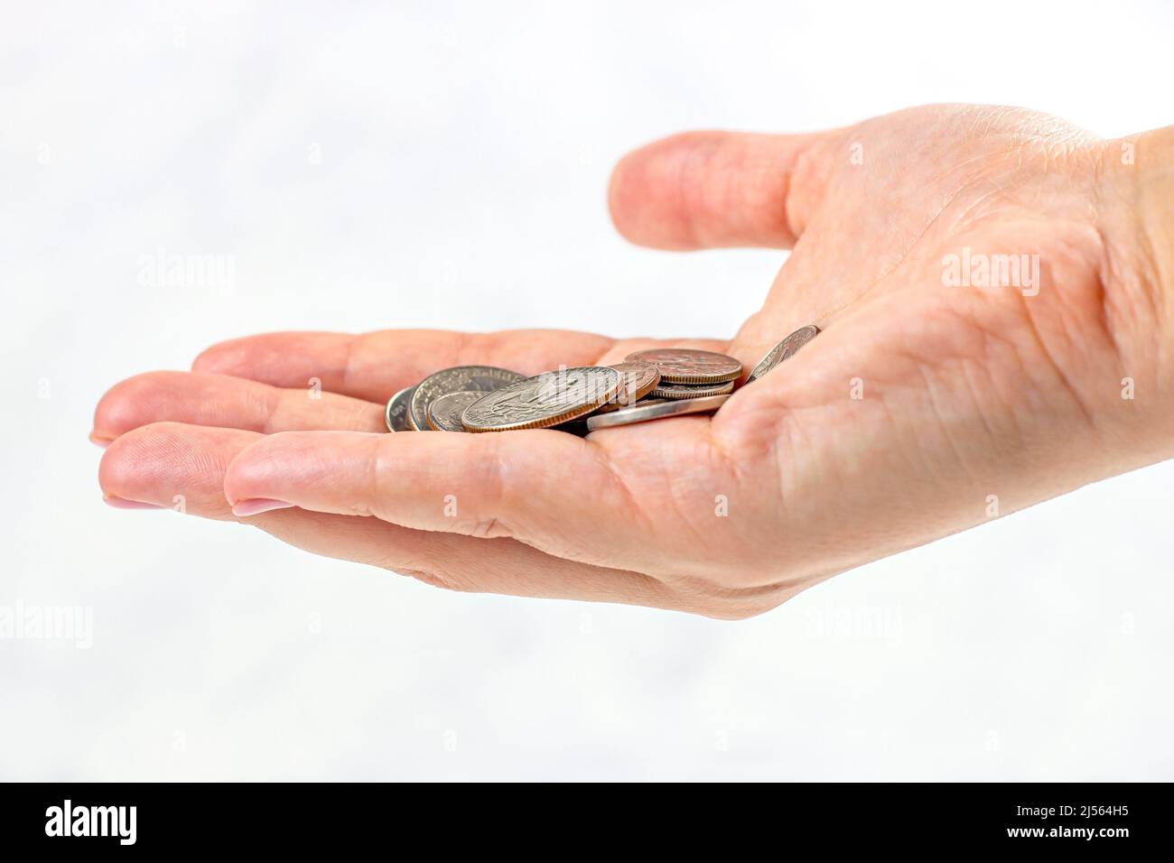 Usa coins in Caucasian woman hands on light background. Money, tips and ...