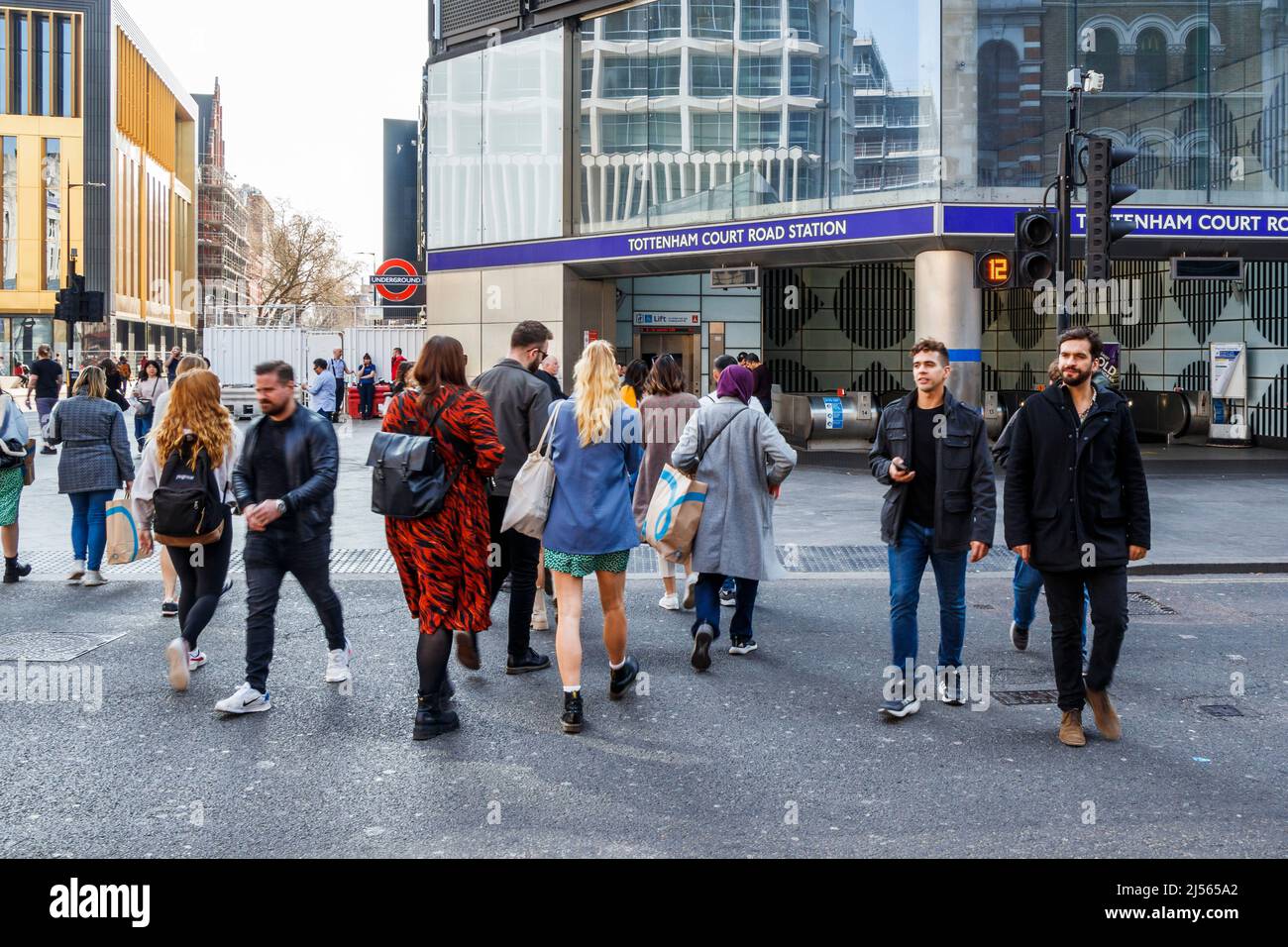 Pedestrians crossing the road outside Tottenham Court Road underground ...