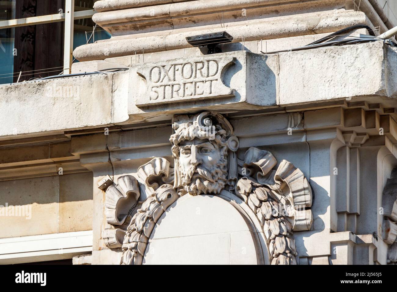 Carved-stone street name and sculpture on Oxford Street, London, UK ...