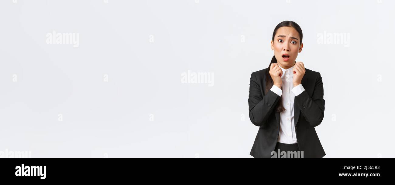 Worried and shocked asian female entrepreneur in suit hear worrying ...