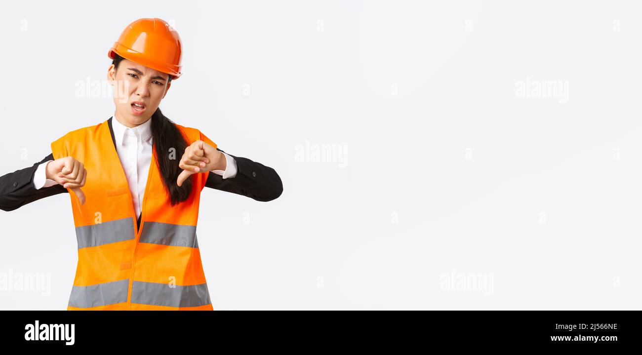 Disappointed and upset asian female chief engineer inspect bad work ...