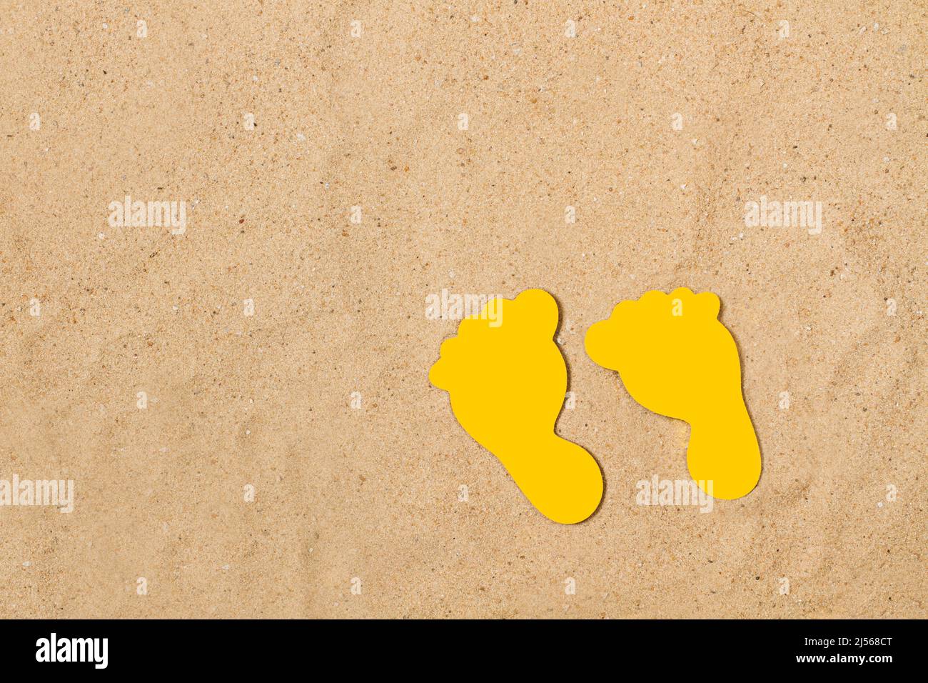 Wooden yellow footprints on a sand background with copy space Stock ...