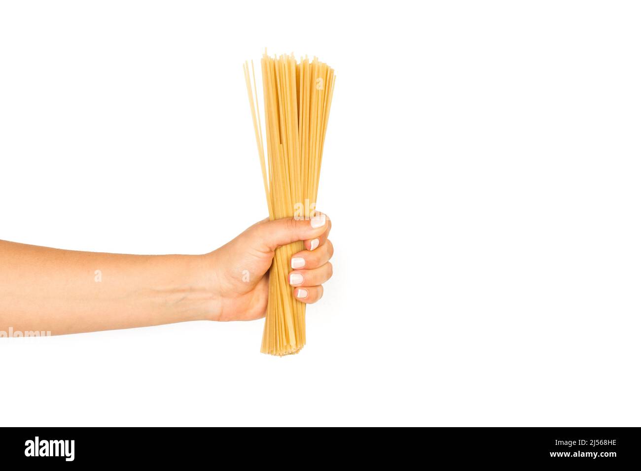 Woman hand holding raw noodles on a white background with copy space ...