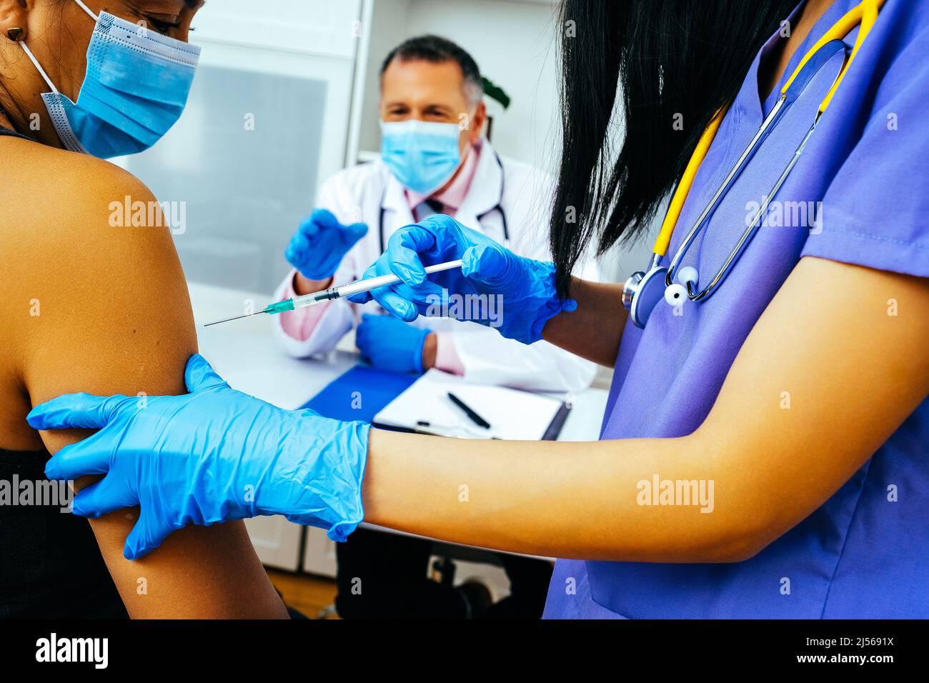 closeup nurse making injection to female patient in doctor's office healthcare industry Stock ...