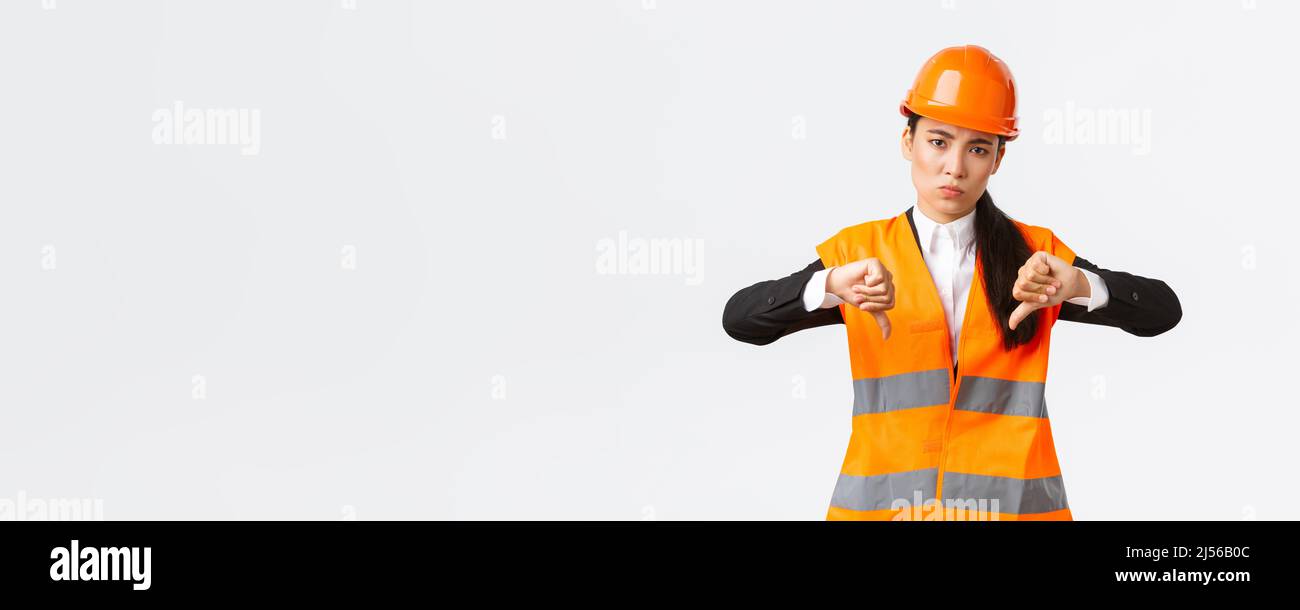 Disappointed and upset asian female chief engineer inspect bad work ...