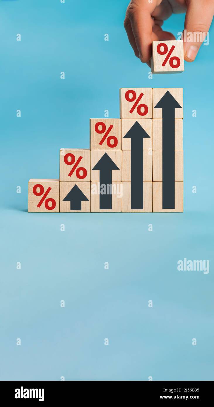 Wooden blocks with percentage sign and arrow up, financial growt Stock ...
